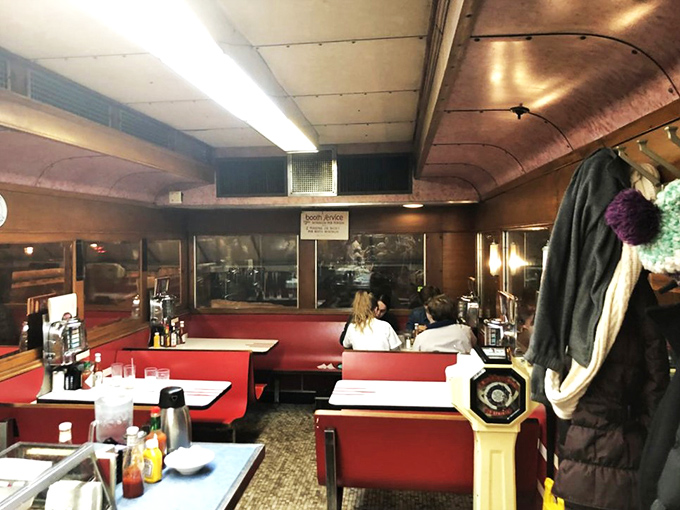 Step inside and travel back in time. Mickey's cozy interior is a warm embrace of wood paneling, red vinyl, and the promise of hearty meals to come.
