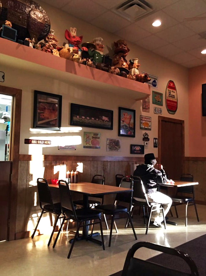 Pig figurines stand guard over diners like meaty sentinels. The wood paneling and simple tables say, "We're serious about barbecue, not interior design."