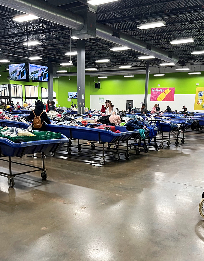 Blue boats of possibility stretch across the warehouse floor. Each bin contains someone's discarded items waiting for their second chance at usefulness.