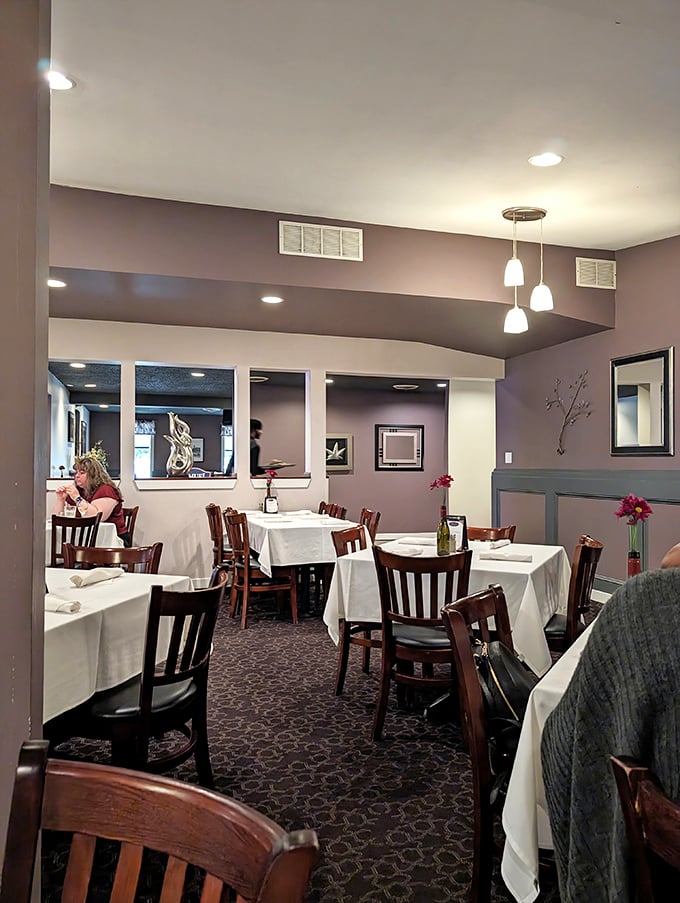 White tablecloths and purple walls create an atmosphere that's both elegant and comfortable&mdash;like dining at your sophisticated friend's house.