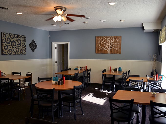 Cozy meets chic in this dining room. The tree artwork whispers, "Branch out and try something new," while the tables practically beg you to settle in for a feast.