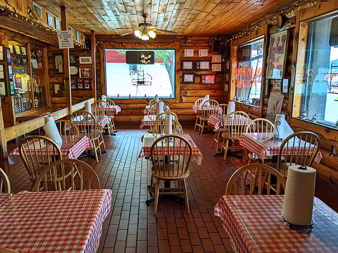 Step into BBQ paradise! This cozy cabin-like interior is where checkered tablecloths meet award-winning walls, and every seat feels like the best seat in the house.