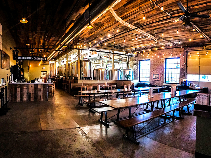 Step into a beer lover's dream! The interior of Laughing Sun Brewing Co. is a perfect blend of industrial chic and cozy pub, with gleaming brewing equipment on full display.