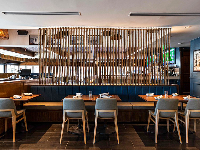 Rope dividers and modern furnishings create an ambiance that's part upscale yacht, part cozy beach house. It's "The Love Boat" meets "Coastal Living."