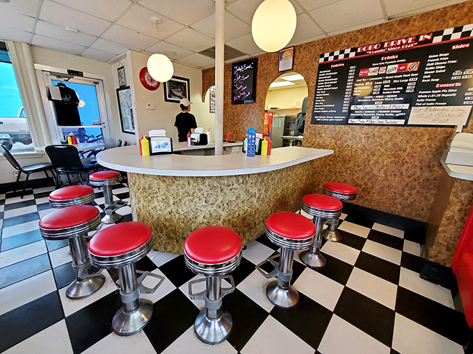 Slide into a slice of Americana! These cherry-red stools aren't just seats; they're front-row tickets to a culinary time warp.
