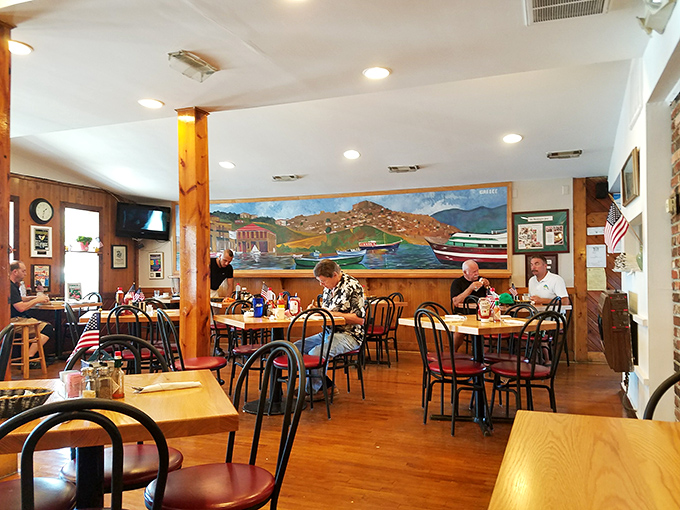 Step into a time capsule of cozy charm. This dining room feels like a warm hug from your favorite aunt, complete with local art and a mural that'll make you forget you're not oceanside.