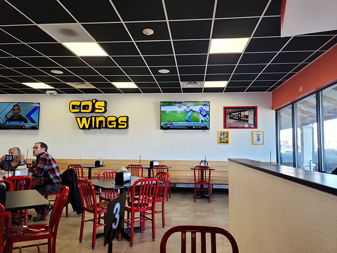 Step inside and feel the wing-fever! Red chairs and sports on TV set the stage for your taste bud adventure.