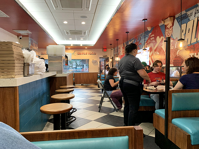 Welcome to the heart of nostalgia! Sip & Bite's interior is a symphony of checkered floors, cozy booths, and the unmistakable buzz of a classic American diner.