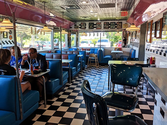 Inside, the classic blue vinyl booths and checkered floor create the perfect backdrop for life's conversations. This isn't just a meal; it's theater in the round with breakfast as the star.