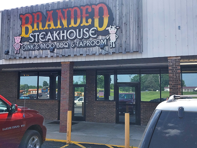 Branded Steakhouse: Where pigs and cows unite! This colorful sign promises a flavor fiesta that'll have your taste buds doing the cha-cha.