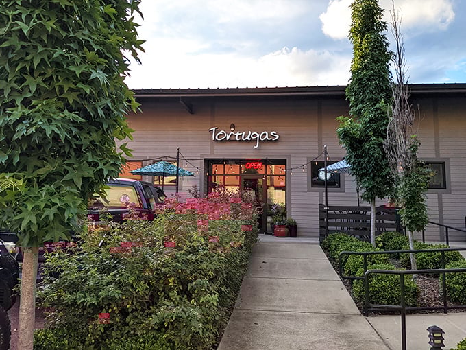 Tortugas Pizza: A floral welcome mat to pizza paradise. This charming facade promises a slice of happiness.