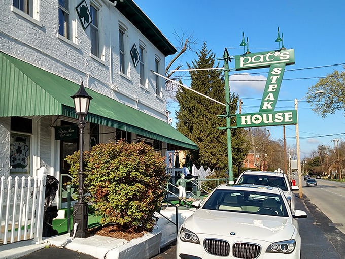Green awnings and white brick? Pat's isn't putting on airs. But inside, they're grilling up steaks that'll make you forget your own name.