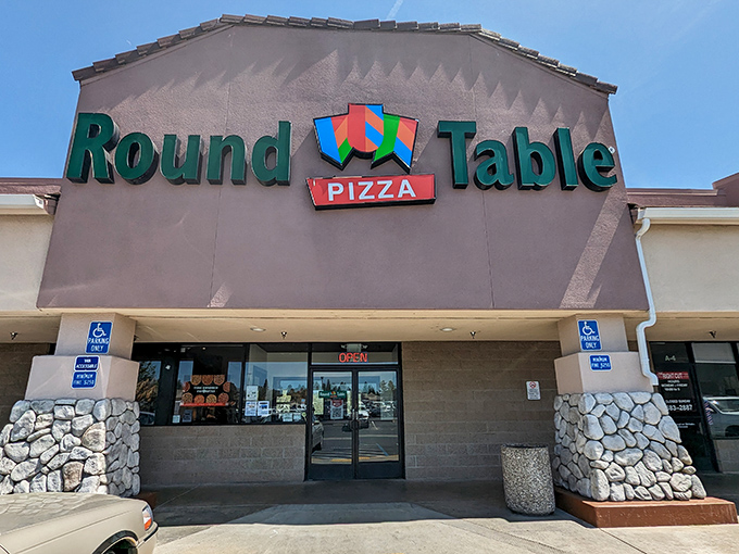 Pizza with a side of nostalgia. Round Table's retro sign promises a feast that'll transport you back to the golden age of arcade games and hair bands.