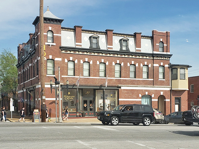 The Hermann Crown Suites building holds court on Main Street, its distinctive mansard roof nodding to a time when architectural flourishes weren't considered showing off.