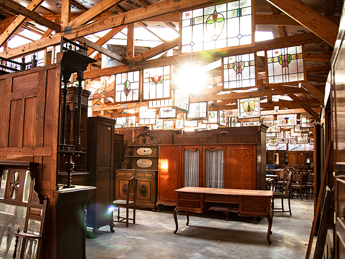 Sunlight dances through stained glass, illuminating a forest of furniture. It's like walking into your grandma's attic &ndash; if she collected everything cool.