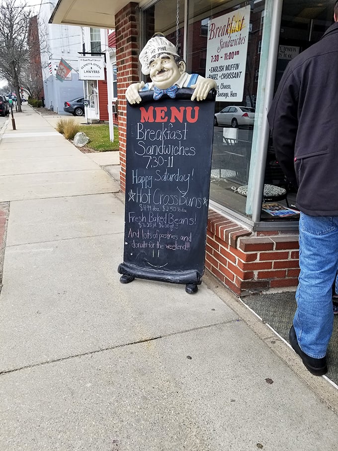 Meet the bakery's unofficial greeter - a jolly chef statue with a menu that's sure to make your stomach rumble and your wallet open.