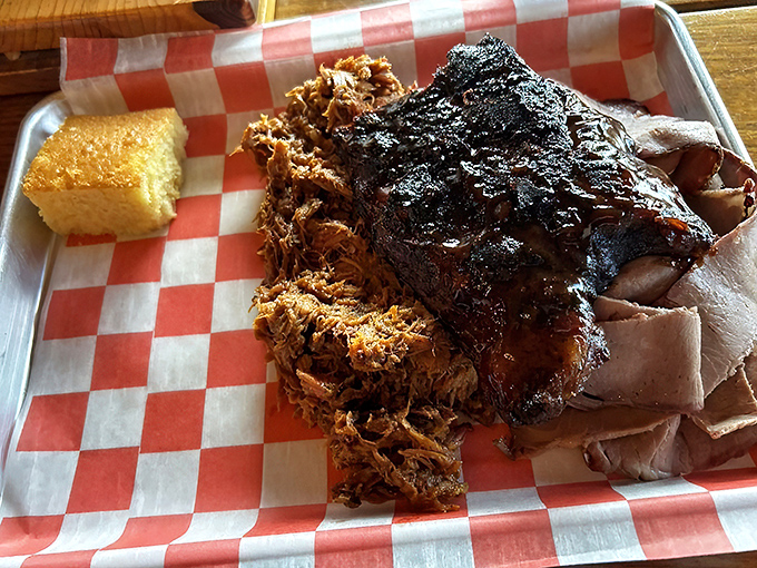 Behold the Piggy Plate&mdash;where pulled pork and ribs coexist in harmony like the world's most delicious peace treaty. That cornbread isn't just a side, it's essential equipment.