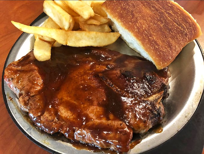 Holy smoke rings, Batman! This BBQ pork steak looks like it's been kissed by the gods of flavor. Pair it with those golden fries for a match made in heaven.