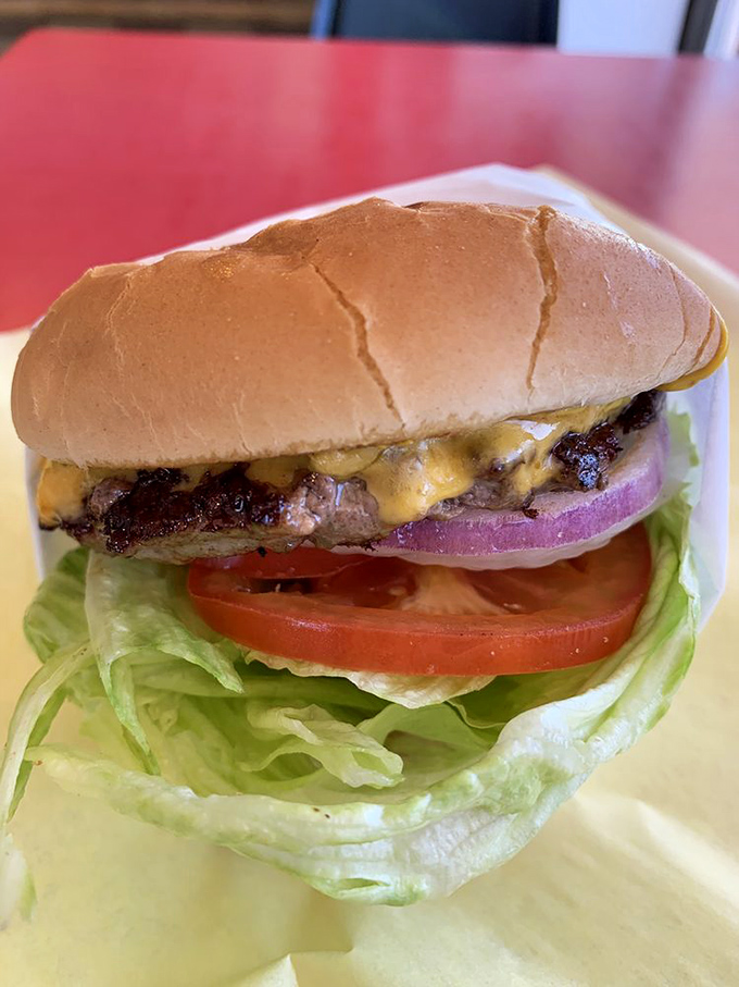 Holy cow! This cheeseburger is so perfectly stacked, it could give the Leaning Tower of Pisa a run for its money.