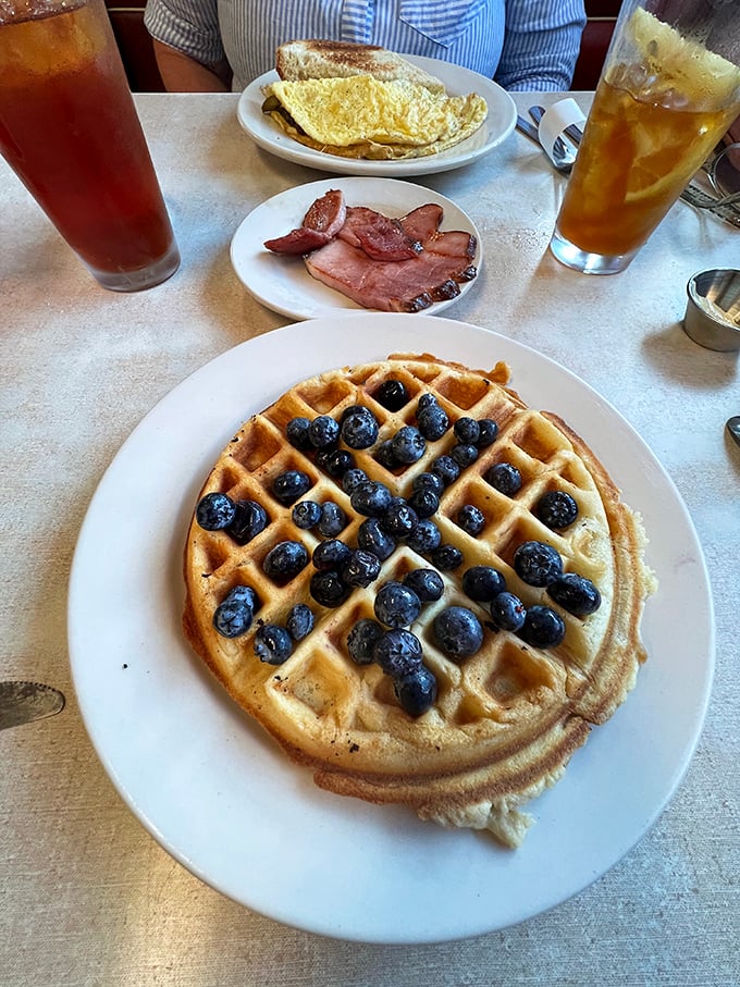 Blueberry bonanza! This waffle's so loaded, it's like someone mugged a berry patch and dumped the loot on your plate.