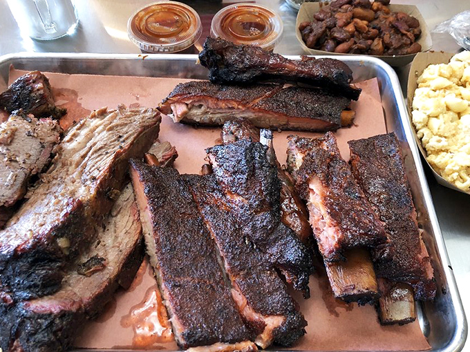 Behold, the holy grail of barbecue! These ribs and brisket look so good, they might just make vegetarians reconsider their life choices.