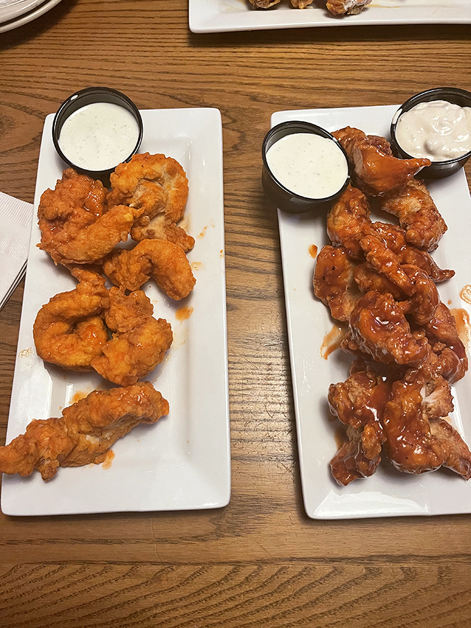 Two plates of wing perfection&mdash;one crispy, one saucy&mdash;flanked by house-made dipping sauces. This is what dreams look like at 2 a.m.