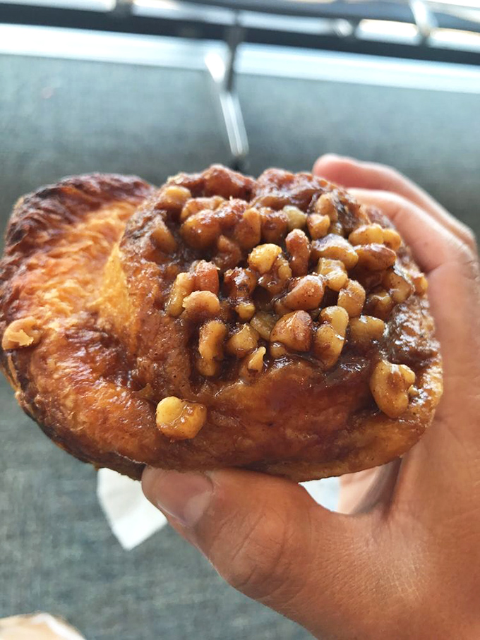 Holy sticky buns, Batman! This cinnamon roll, crowned with candied nuts, is the superhero your taste buds have been waiting for.