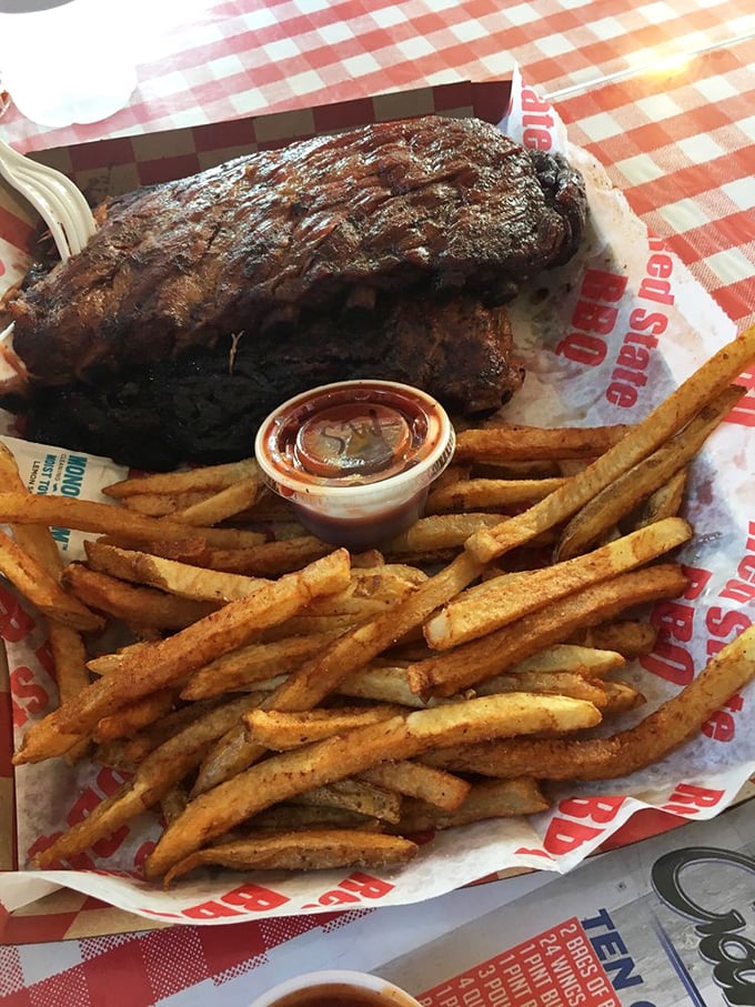 Holy smokes! That's not a rack of ribs, it's a meaty masterpiece. Paired with those golden fries, it's a plate that would make Fred Flintstone jealous.