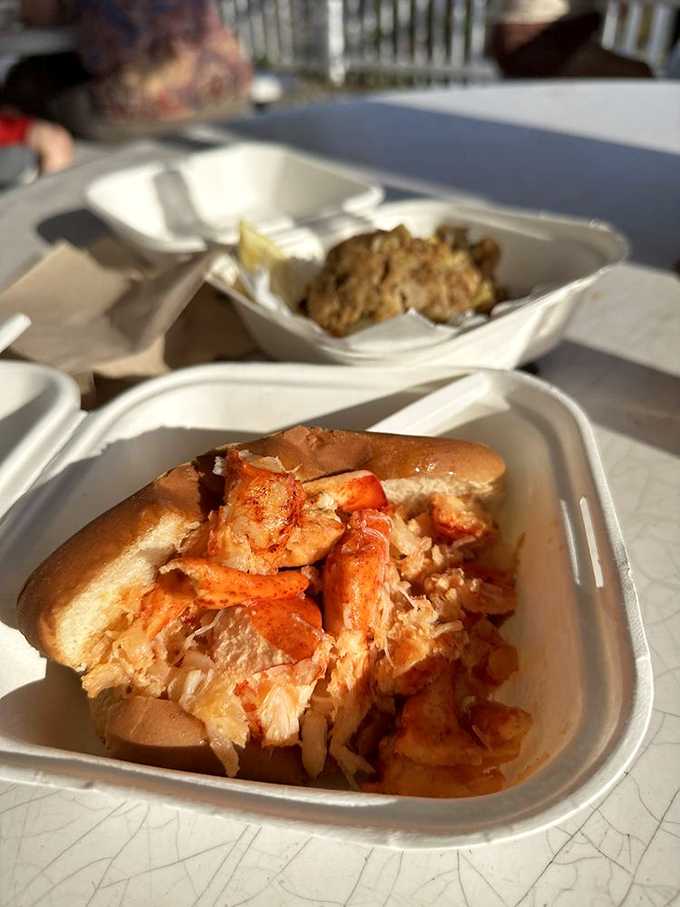 The lobster roll: a buttery throne fit for the king of crustaceans. This sandwich is so packed, it's like the lobsters volunteered as tribute.