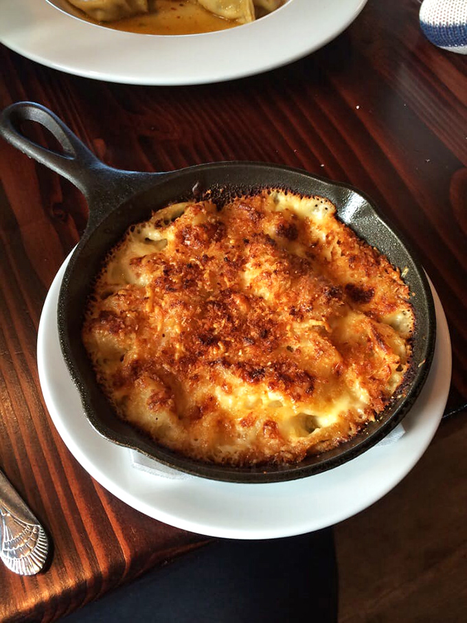 Behold the holy grail of comfort food! This cast-iron skillet of mac and cheese isn't just a dish – it's a religious experience with a golden-brown halo.
