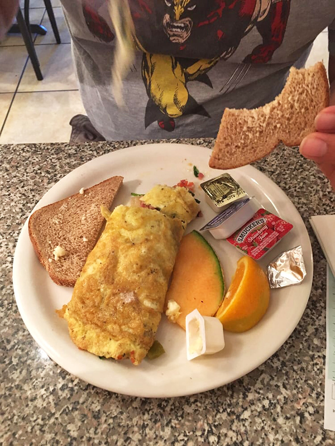 Eggs-cellence on a plate! This omelet is so perfectly folded, it could teach origami masters a thing or two.