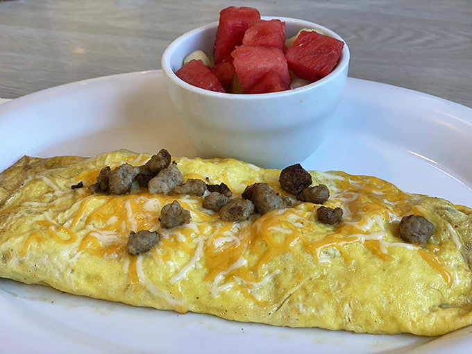 Egg-cellence achieved! This omelet's so fluffy, it might float away if not for its hearty sausage anchor.
