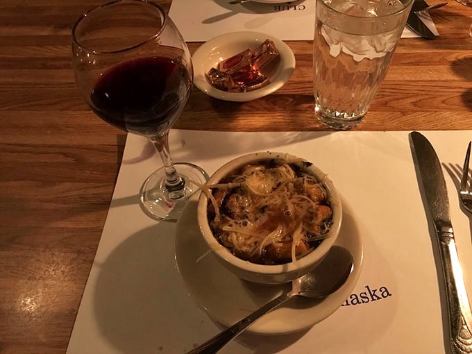 A bowl of comfort, a glass of joy. This French onion soup could make even the Mona Lisa crack a smile, paired perfectly with a robust red.