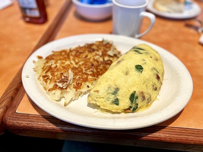 Popeye would trade his spinach for this bad boy. An omelet so fluffy, it might float away if not for that anchor of crispy hash browns.