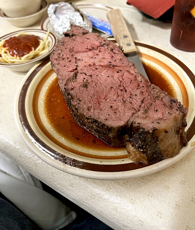 Behold the star of the show: prime rib so perfectly pink it should have its own Instagram account. That seasoned crust deserves a standing ovation.