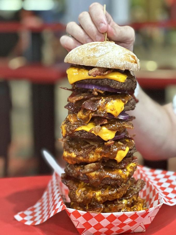 The Quadruple Bypass Burger: Where excess meets excellence. It's a towering testament to the art of burger stacking &ndash; and your willpower. Photo credit: J&oacute;n D.