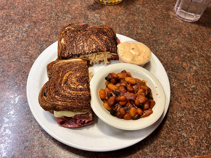 The Reuben: where corned beef meets sauerkraut in a dance of deliciousness. It's like a deli took a vacation to the Midwest.