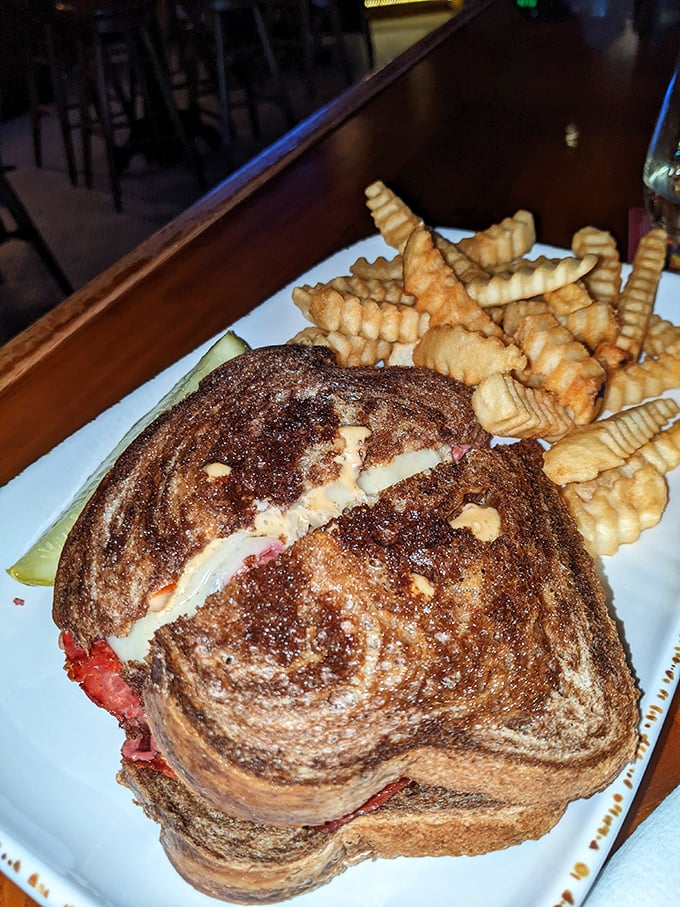 The Reuben has entered the building! This sandwich is stacked higher than Elvis's pompadour, with a side of crispy, golden fries fit for The King.