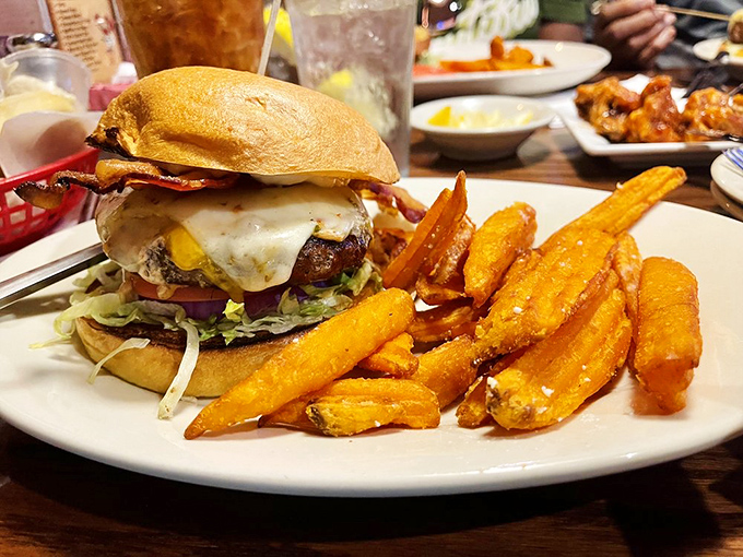 Holy cow! This burger's stacked higher than my retirement portfolio. It's a towering tribute to the noble art of sandwich engineering.