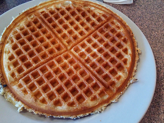 Golden perfection on a plate! This waffle's crispy exterior and fluffy interior are the Batman and Robin of breakfast duos.