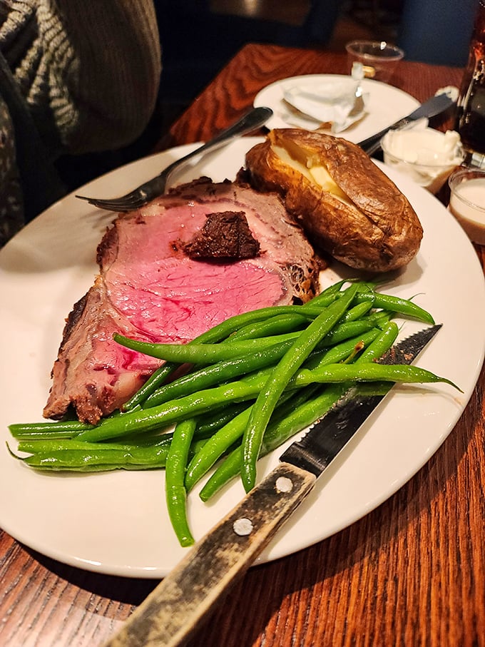 Behold, the star of the show! This prime rib is so perfectly pink, it could make a vegetarian weep. Paired with a baked potato and green beans, it's a classic trio.