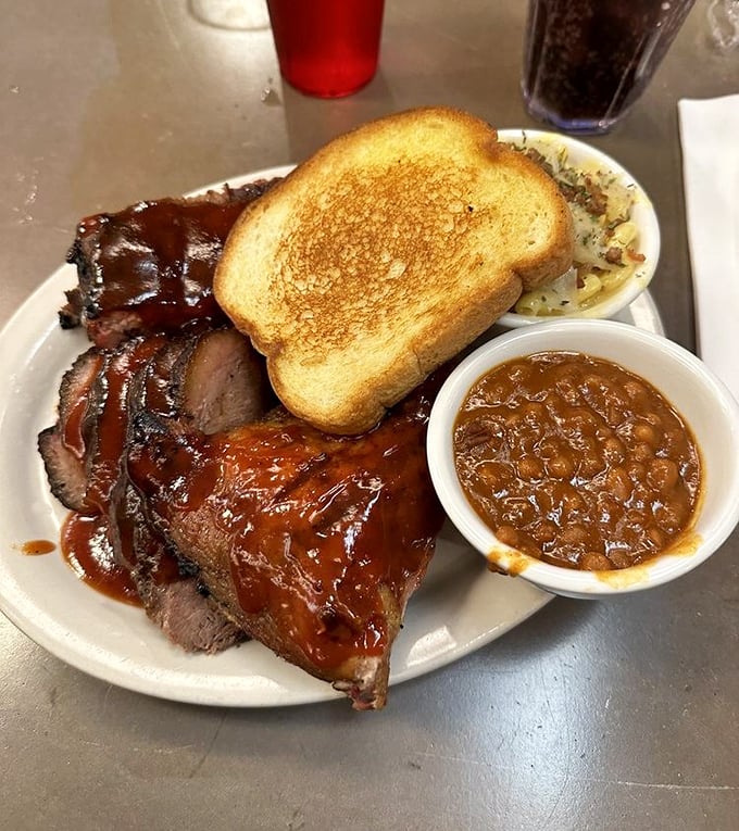The holy trinity of barbecue: brisket, chicken, and ribs. It's like the Avengers of meat, assembled on one glorious plate.