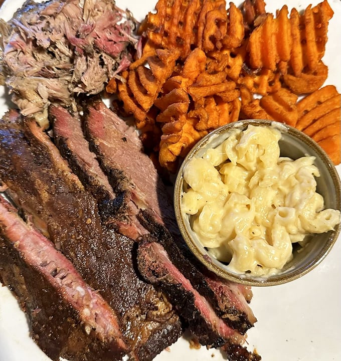 The holy trinity of BBQ! This 3-meat combo is a carnivore's dream, featuring brisket, pulled pork, and ribs that'll make you weak in the knees.