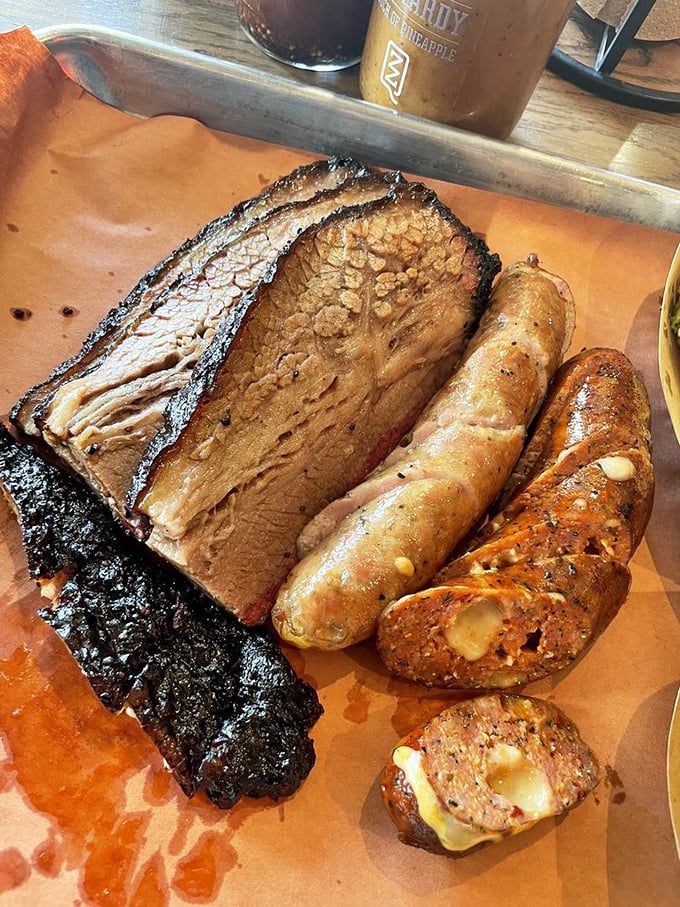 Brisket with that perfect smoke ring and sausages bursting with juicy goodness&mdash;this tray isn't lunch, it's a religious experience on butcher paper.
