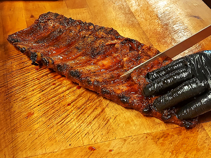 Holy smoke rings, Batman! These ribs look so tender, they might just fall off the bone if you whisper "barbecue" too loudly.
