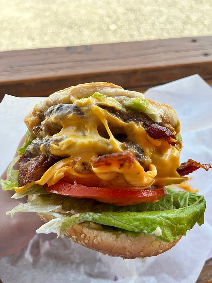 Holy moly, that's a handful! This bacon cheeseburger isn't just a meal, it's a delicious challenge to your jaw's ambitions.