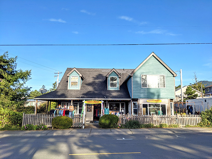 Beach town charm distilled: white picket fence, colorful merchandise, and that unmistakable "you're officially on vacation" coastal architecture.