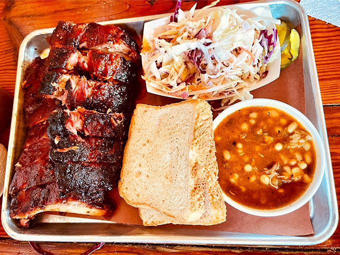 Behold, the holy trinity of barbecue! This platter is so mouthwatering, it could make a vegetarian question their life choices.
