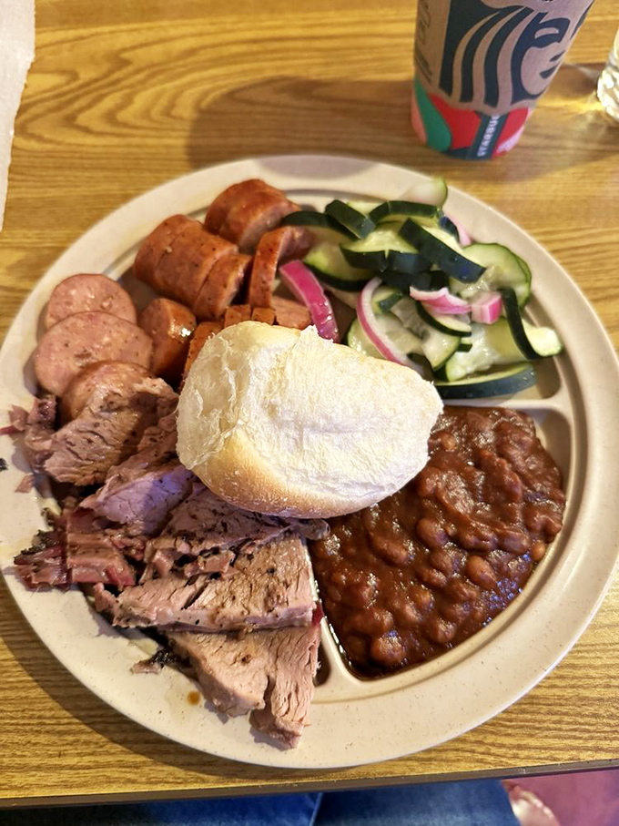 Holy smokes! This plate is a meat lover's fantasy come true. Tender brisket, juicy sausage, and sides that'll make your taste buds do a happy dance.