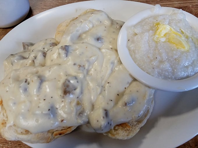 The holy trinity of Southern breakfast: biscuits smothered in gravy, with a side of creamy grits. It's like a warm hug for your stomach.